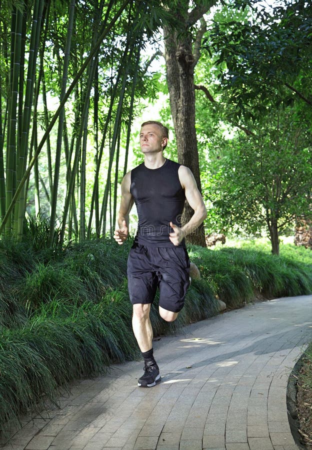 Fit and Healthy Caucasian Man Running in Park Stock Photo - Image of ...