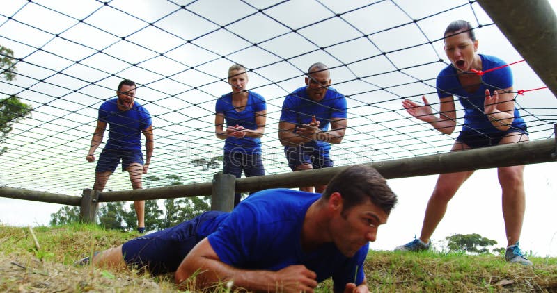 Fit Men Crawling Under the Net during Obstacle Course 4k Stock Video ...