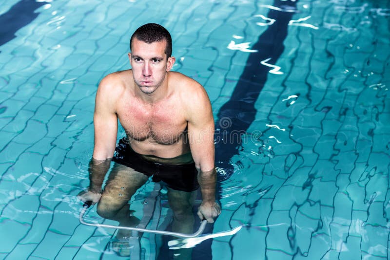 Fit Man Cycling in the Pool Stock Image - Image of center, activity ...