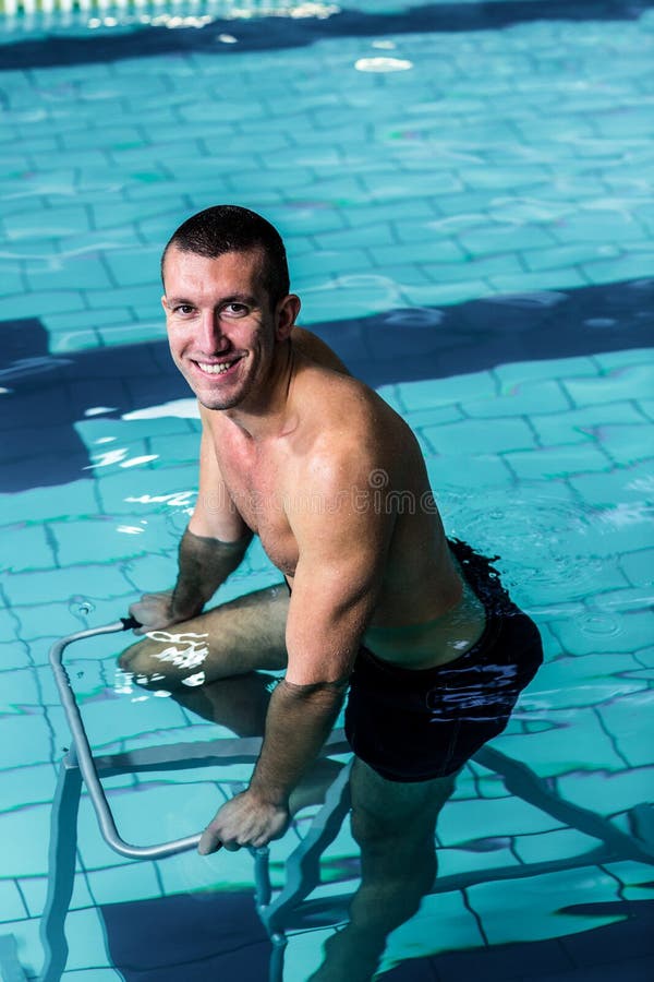 Fit Man Cycling in the Pool Stock Image - Image of adult, sporty: 64974823