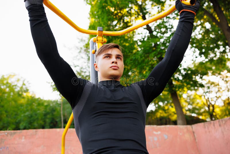 Fit Man Doing Triceps Dips on Parallel Bars at Park Exercising Outdoors ...