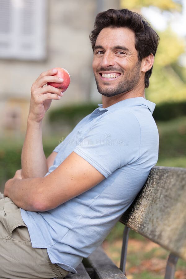 Fit Man Eating Apple in Countryside Stock Image - Image of male ...