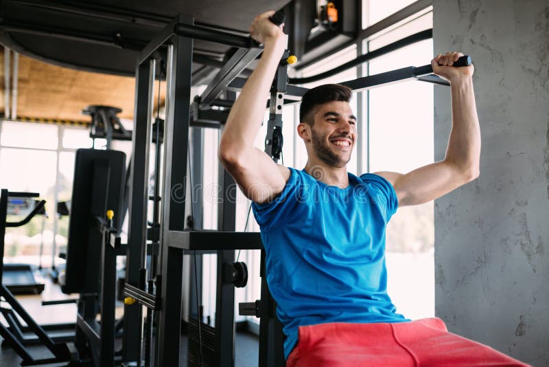 Fit Man Exercising at the Gym on a Machine Stock Image - Image of ...