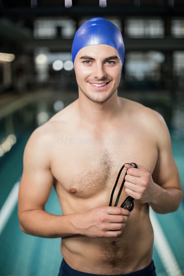 Fit man holding goggles stock image. Image of swimming - 66969895