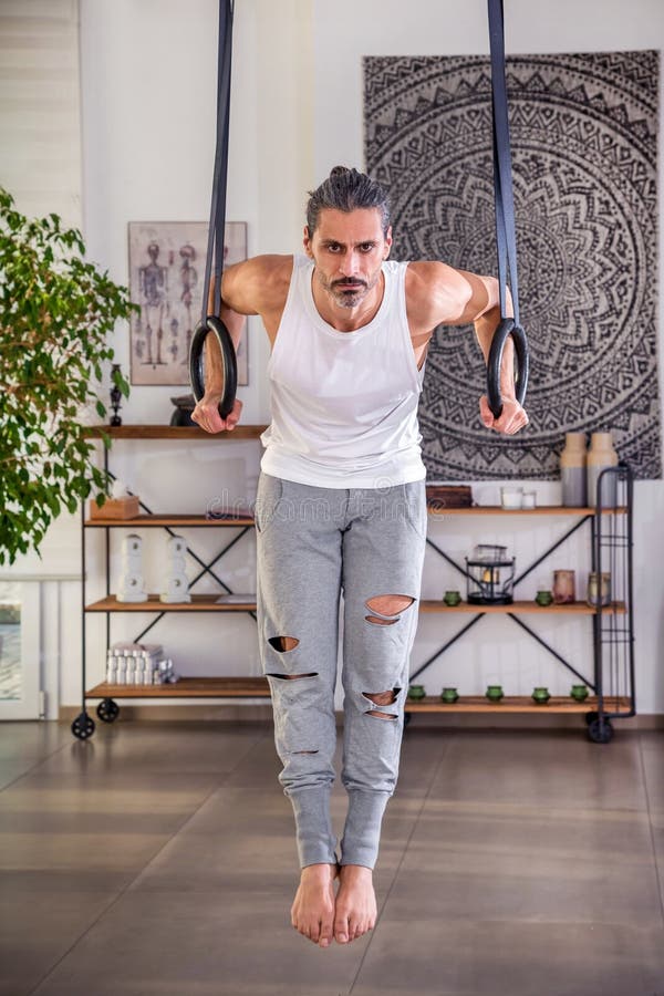Determined Athlete Executing Ring Dips at Gym Stock Photo - Image of ...