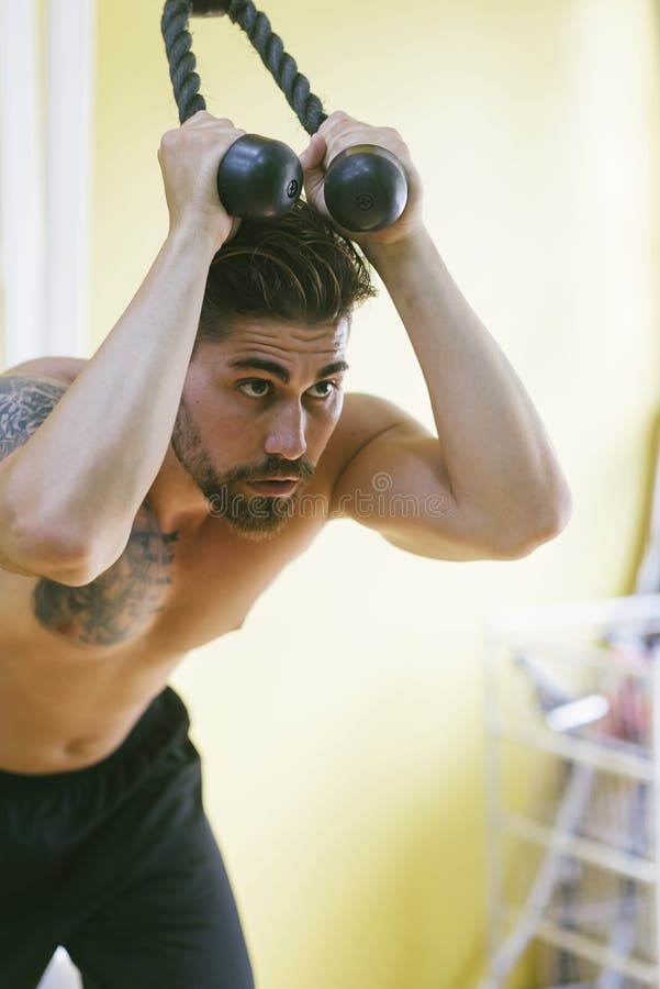 Fit Man on Lat Pull Down Machine at the Health Club. Work Out on Pull ...