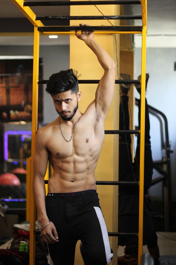 Fit man posing in gym stock image. Image of equipment - 361358561