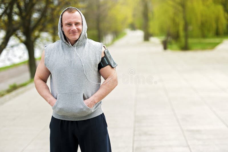 Fit Man Resting after Run Listening Music. Stock Photo - Image of ...