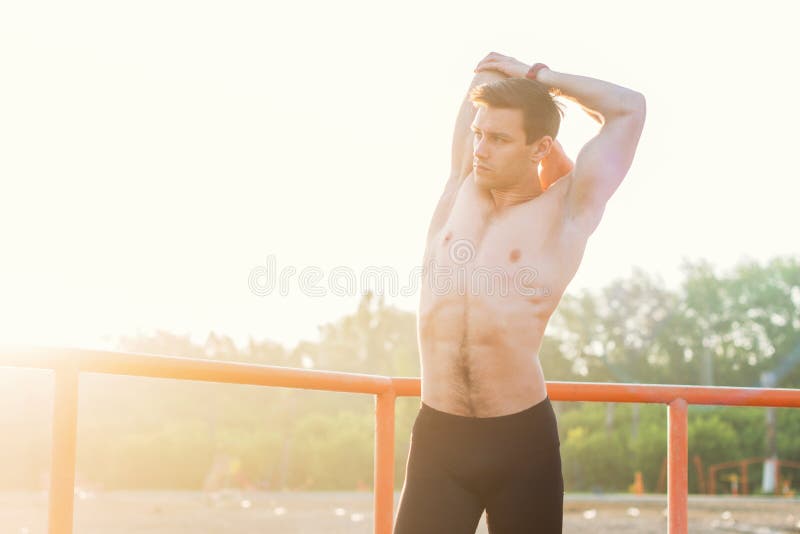 Fit Man Stretching His Arm and Shoulder Warming Up on Fresh Air. Stock ...
