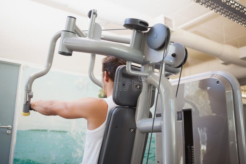 Fit Man Using Weights Machine for Arms Stock Photo - Image of club ...