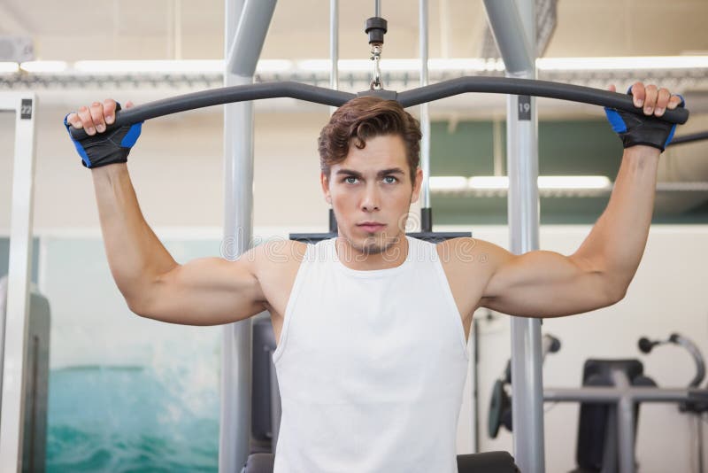 Fit Man Using Weights Machine for Arms Stock Photo - Image of view ...