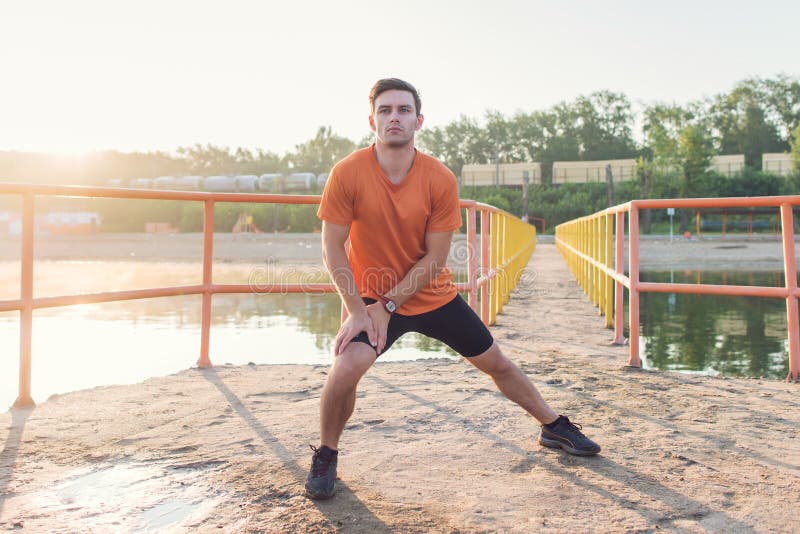 Fit Man Warming Up Doing Lunges Exercising during Morning Run. Stock ...