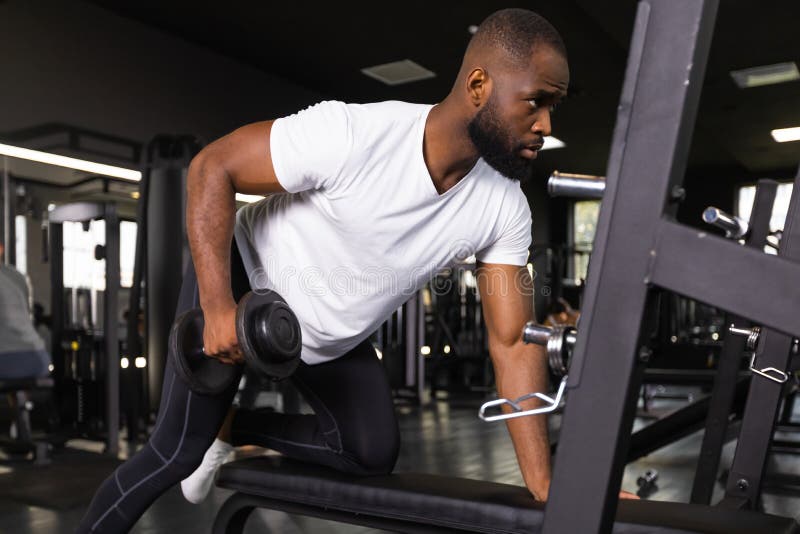 Fit and Muscular African Man Trains with Dumbbells. Stock Photo - Image ...