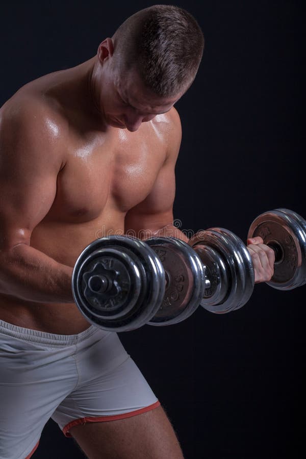 Fit Muscular Man Exercising with Dumbbell Stock Photo - Image of ...