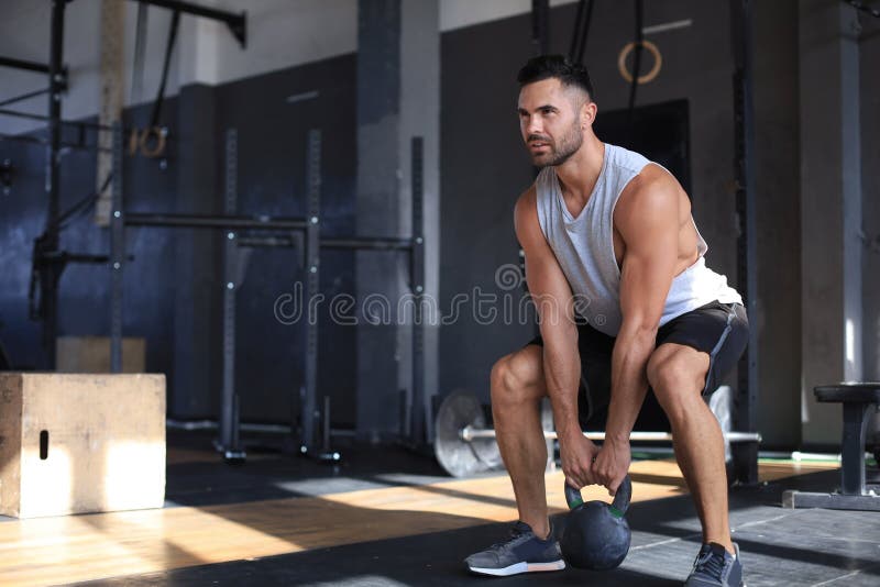 Fit and Muscular Man Focused on Lifting a Dumbbell during an Exercise ...