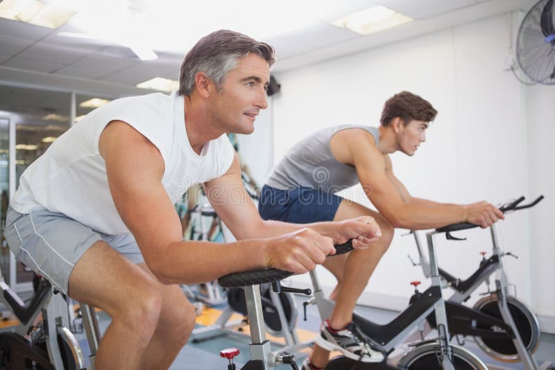 Fit People Working Out on the Exercise Bikes Stock Photo - Image of ...
