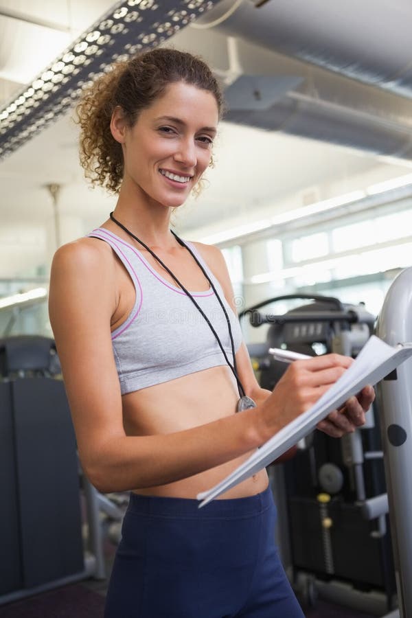 Fit Trainer Taking Notes and Smiling at Camera Stock Image - Image of ...