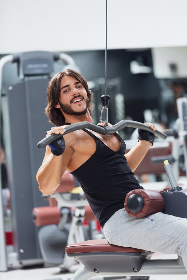 Fit Weightlifter Pulling Bar Attached To Machine Stock Image - Image of ...