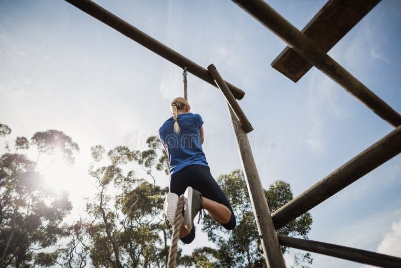 Fit Woman Climbing Down the Rope during Obstacle Course Stock Photo ...