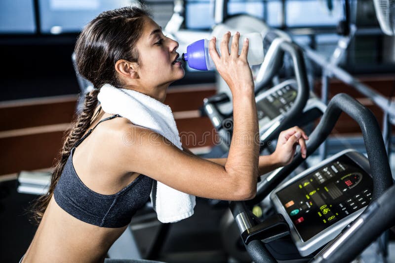 Fit Woman Drinking Water while Doing Bike Exercise Stock Image - Image ...