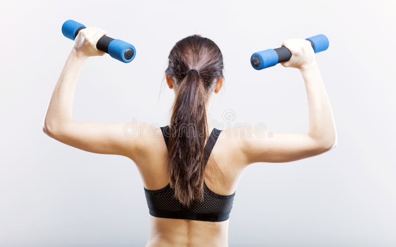 Fit Woman during Exercise with Dumbbells, Back View Stock Image - Image ...