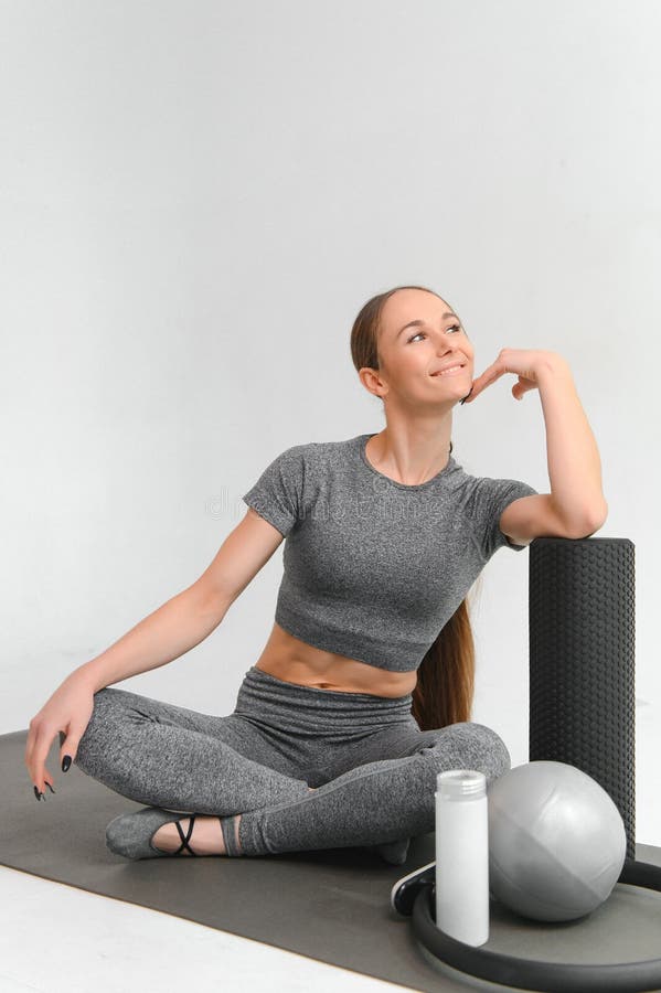 Fit Young Brunette Pilates Instructor Showing Different Exercises on a ...