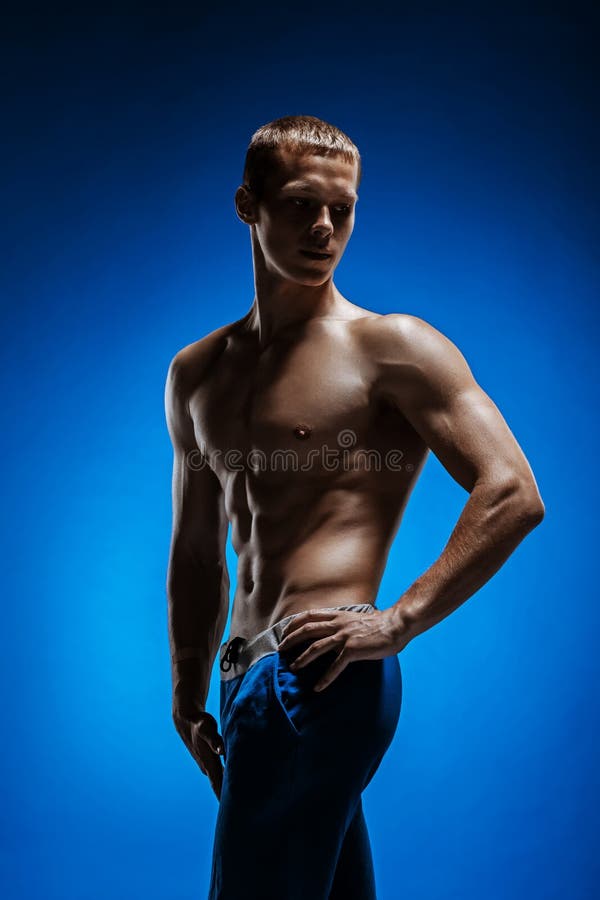 Fit Young Man with Beautiful Torso on Blue Background Stock Image ...