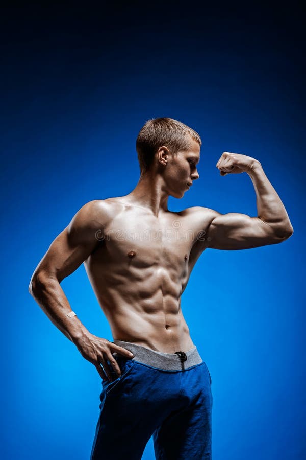Fit Young Man with Beautiful Torso on Blue Background Stock Image ...