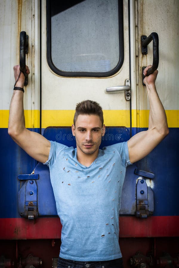 Fit Young Man Hanging from Handles Outside Train Stock Photo - Image of ...