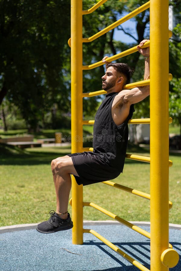 Fit Young Man Performing Abdominal Exercises on Outdoor Bars Stock ...