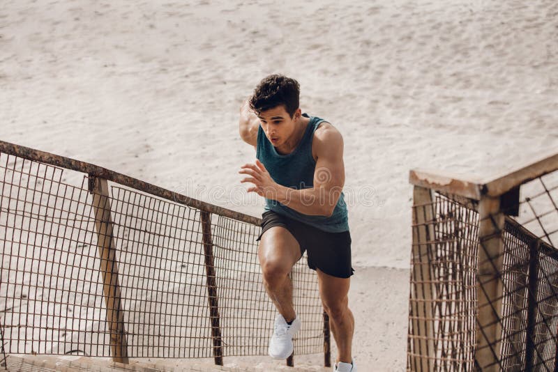 Fit Young Man Running Up the Steps at Beach Stock Photo - Image of ...