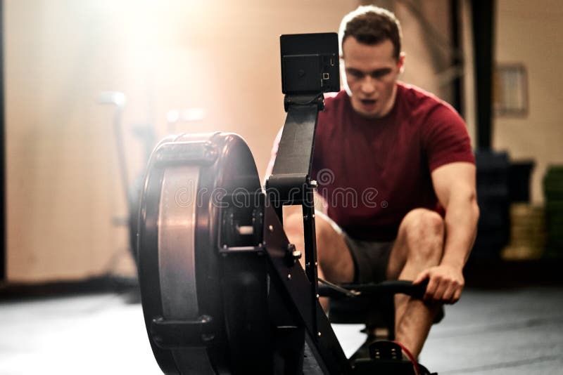 Young Man Doing a Rowing Machine Workout in a Gym Stock Photo - Image ...