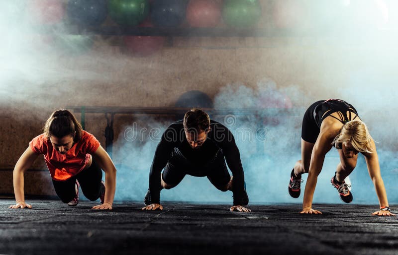 Fit Young People Doing Pushups in a Gym Stock Photo - Image of athlete ...
