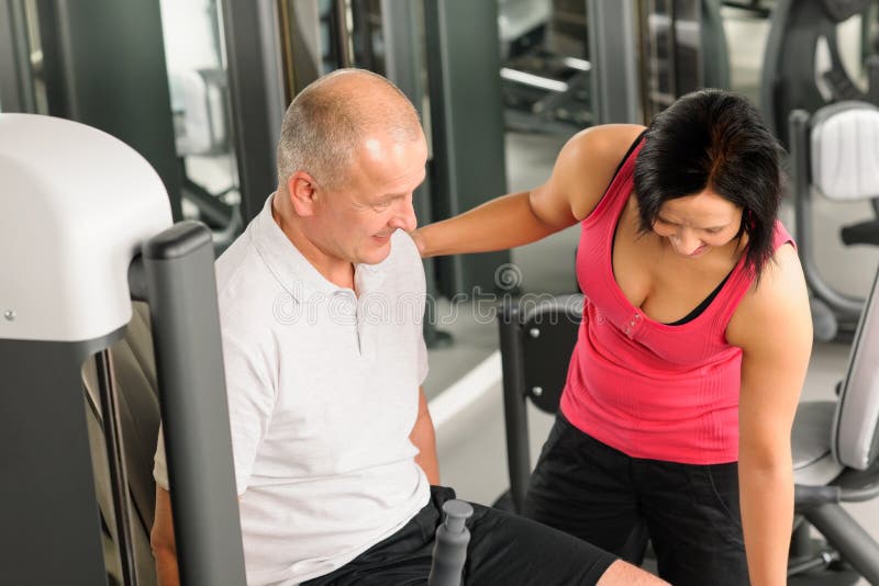 Fitness Center Active Man Exercising with Trainer Stock Photo - Image ...