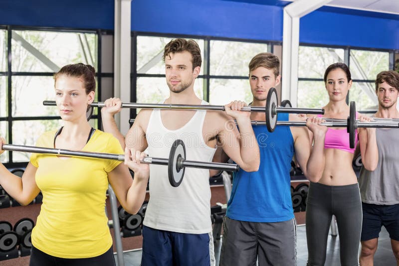 Fitness Class Lifting Barbell Stock Image - Image of fitness, muscle ...