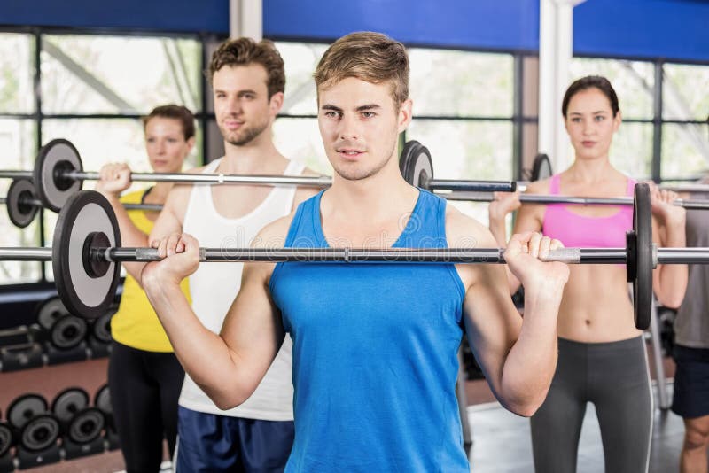 Fitness Class Lifting Barbell Stock Image - Image of equipment, muscle ...