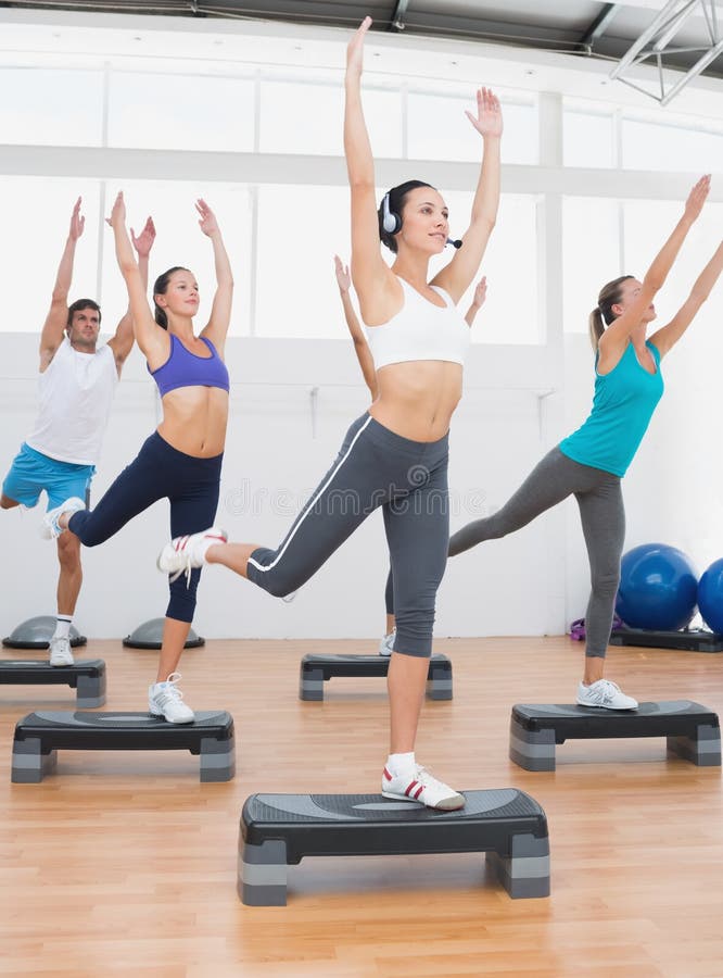 Fitness Class Performing Step Aerobics Exercise Stock Image - Image of ...