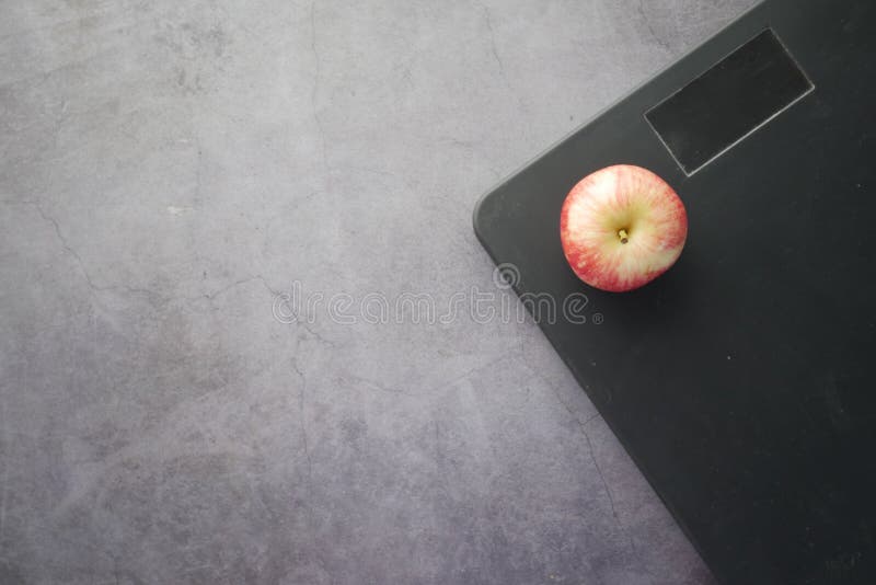 Fitness Concept with Apple and Weight Scale on Black Stock Photo ...