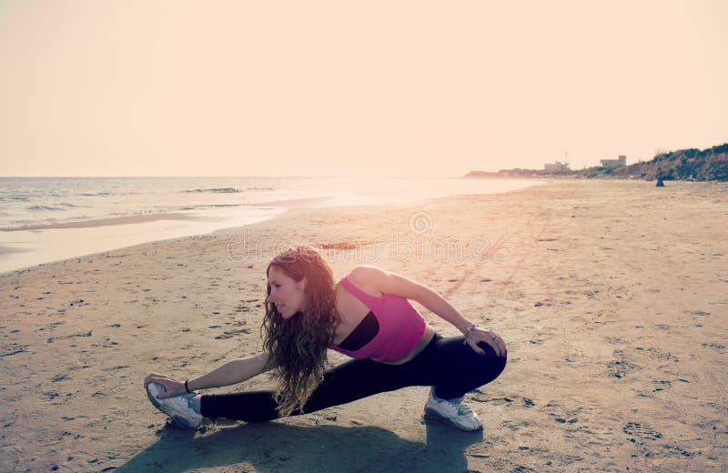Fitness Exercises on the Beach at Sunset Warm Filter Applied Stock ...