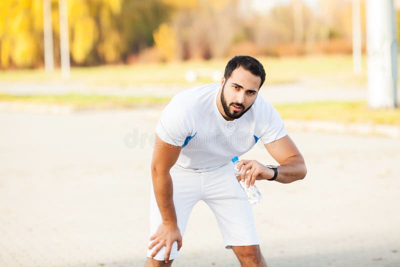Fitness. Exhausted Runner Man Resting on the Park after Workout Stock ...