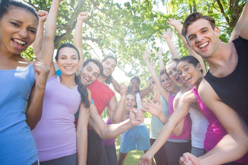 Fitness Group Cheering at Camera in Park Stock Image - Image of female ...