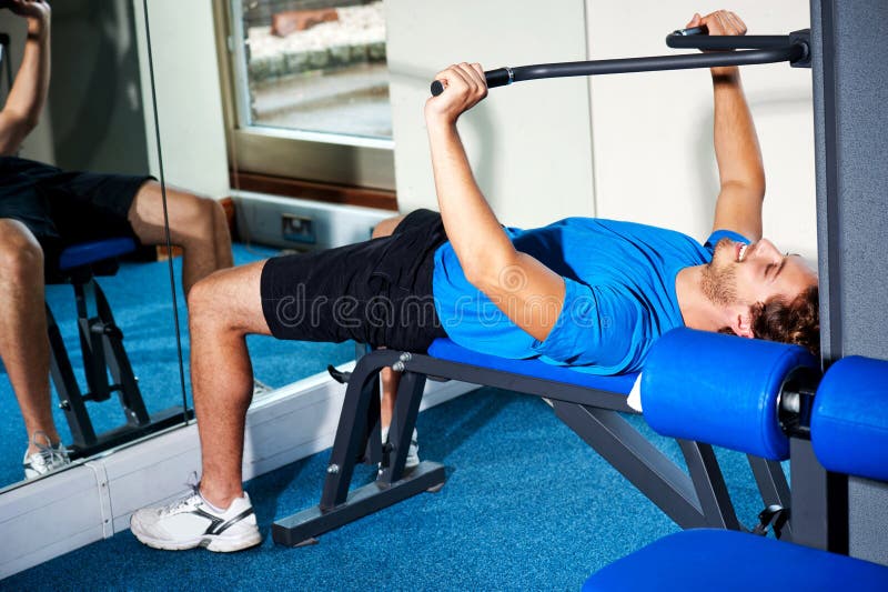 Fitness Guy Lying on Bench and Exercising Stock Photo - Image of ...