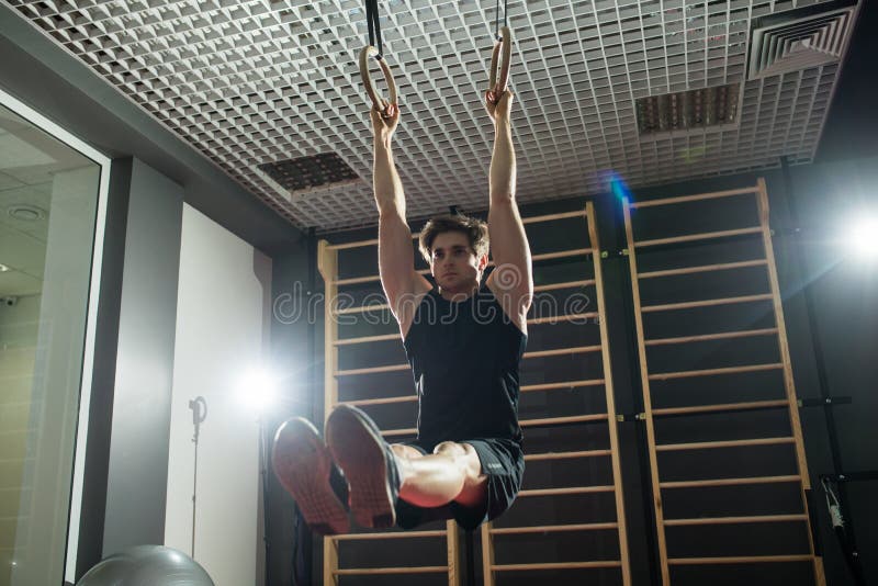 Fitness Handsome Man Doing Dipping Exercise Using Rings in the Gym ...