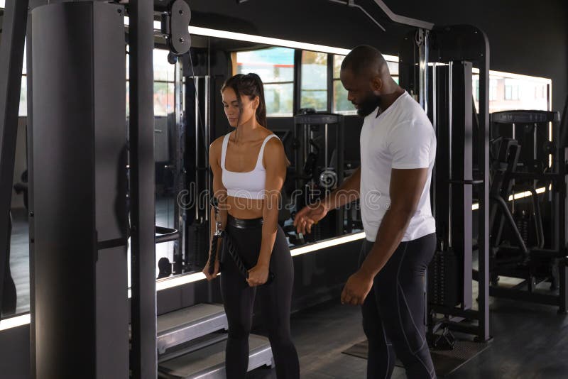 Fitness Instructor Exercising with His Client at the Gym. Stock Image ...