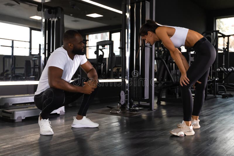 Fitness Instructor Exercising with His Client at the Gym. Stock Photo ...