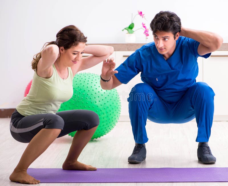 Fitness Instructor Helping Sportsman during Exercise Stock Photo ...