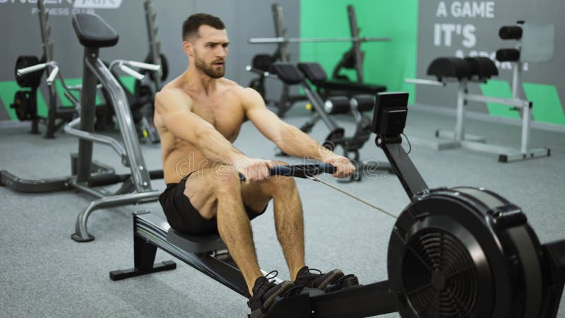 Shirtless Athlete Training Rowing Machine Exercise Intense Endurance ...