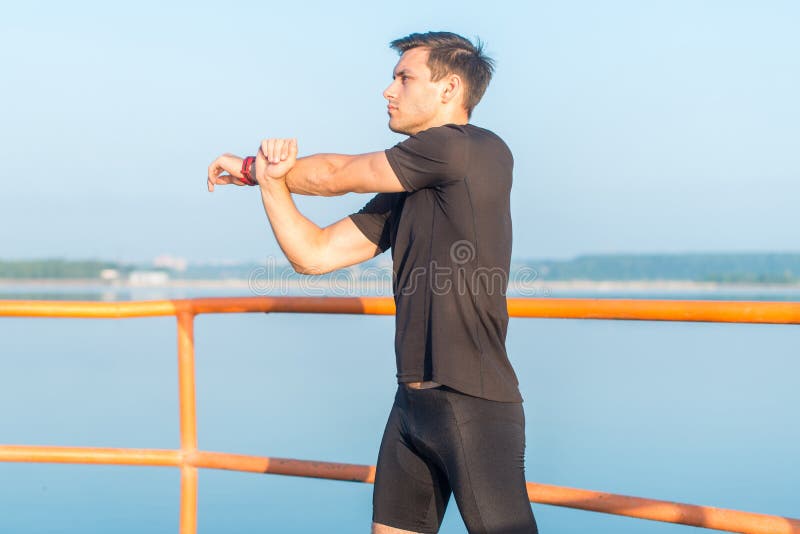 Fitness Man Stretching Arms, Shoulder. Runner Warming Up and Exercising ... Fitness Man Stretching Arms, Shoulder. Runner Warming Up and Exercising ...