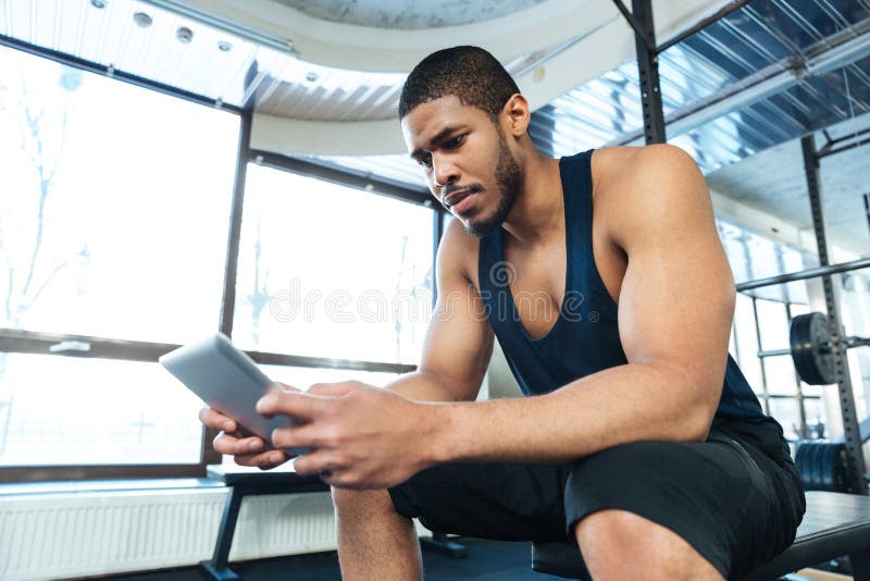 Fitness Man with a Tablet Computer in the Gym Stock Image - Image of ...
