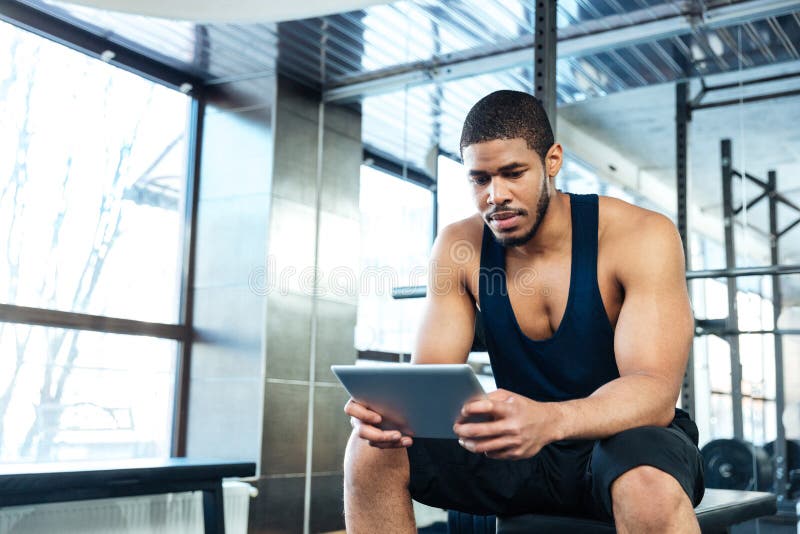 Fitness Man with a Tablet Computer in the Gym Stock Image - Image of ...